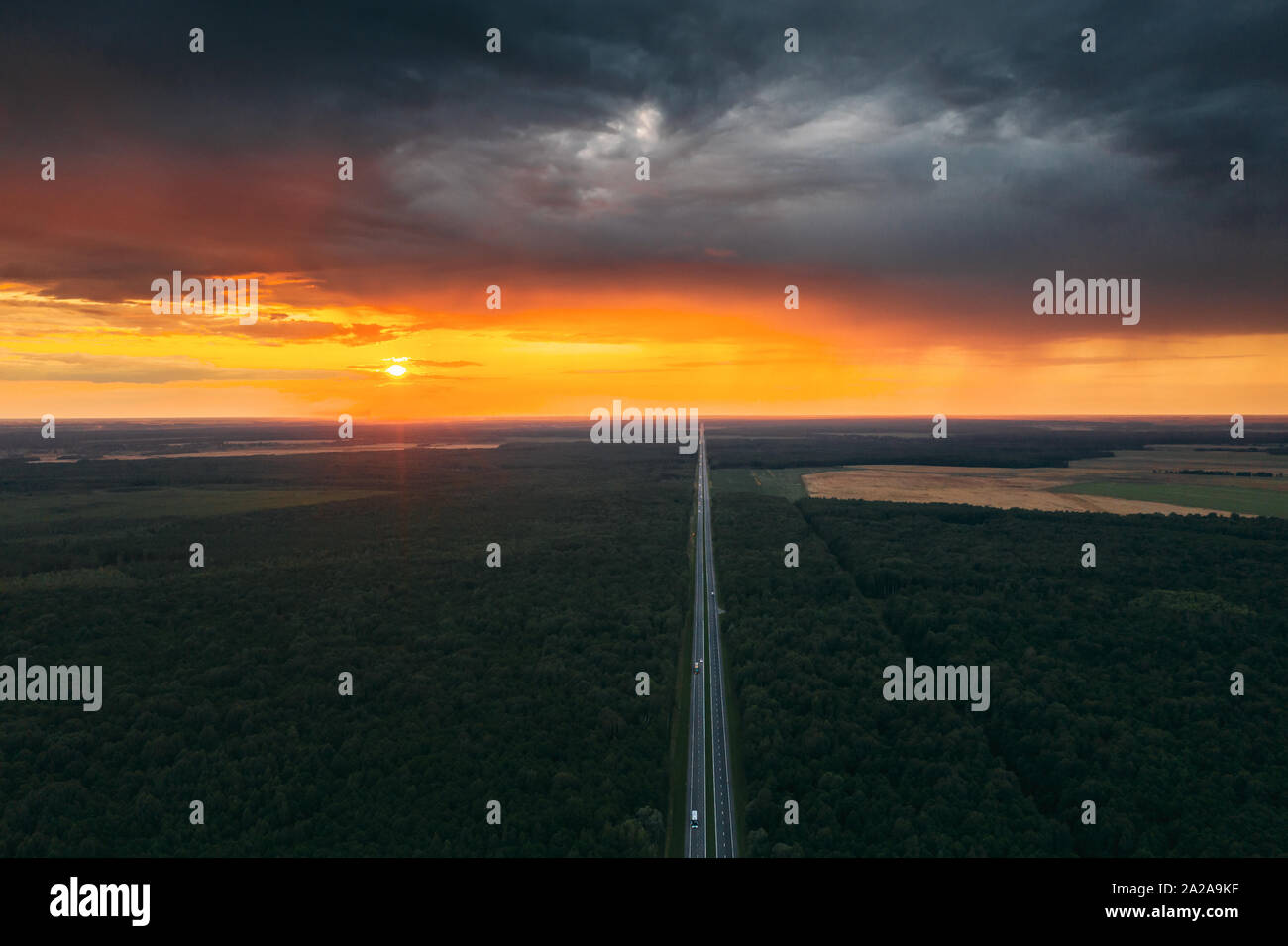 Aerial View Of Sunset Sky Above Highway Road Through Green Forest ...
