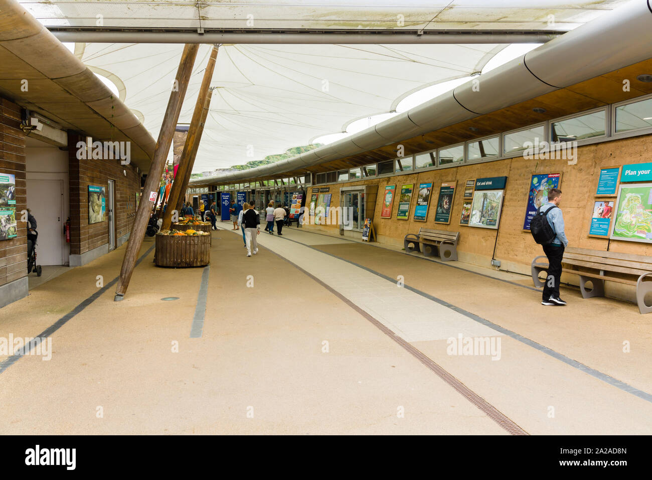 The Eden Project entrance with families and visitors walking through to ...