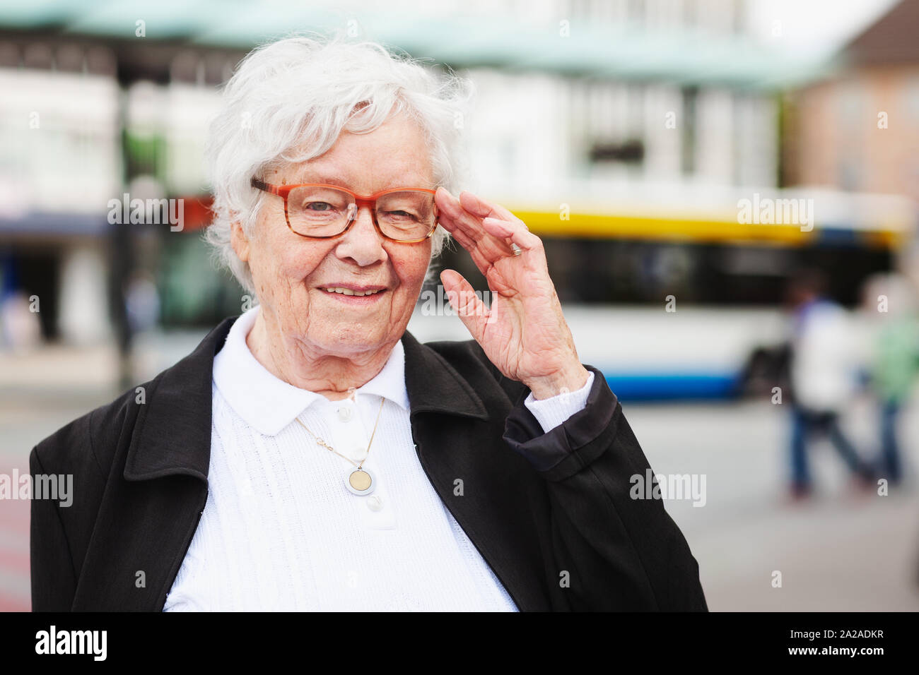 Portrait of old woman on bus station. Travel and active lifestyle ...