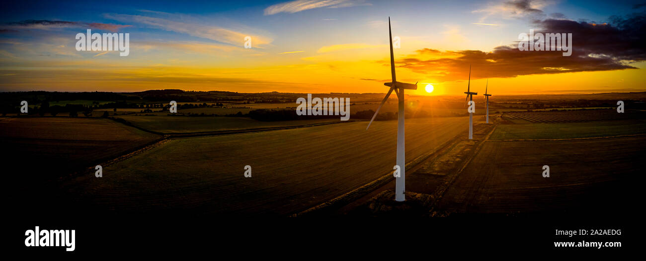 Commercial wind turbines at sunrise on a clear day Stock Photo - Alamy
