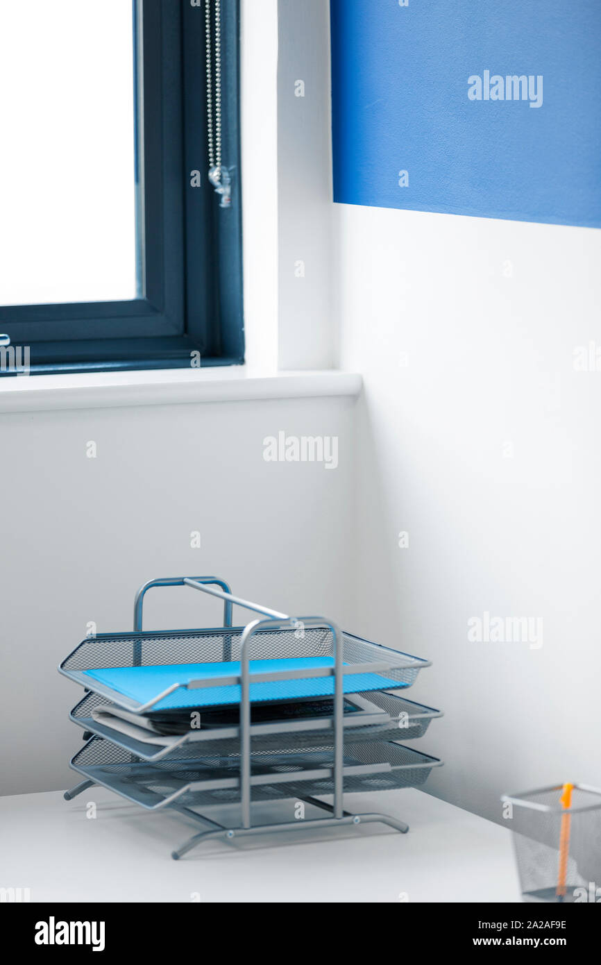 Blue files on a modern office desk Stock Photo - Alamy
