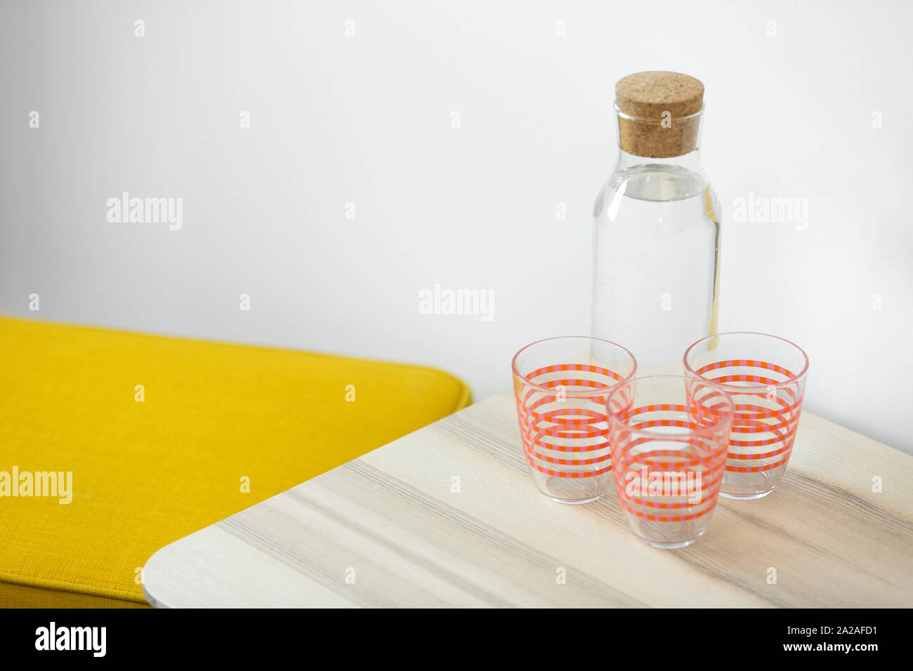 Jug of water and three glasses on a modern office coffee table ready ...