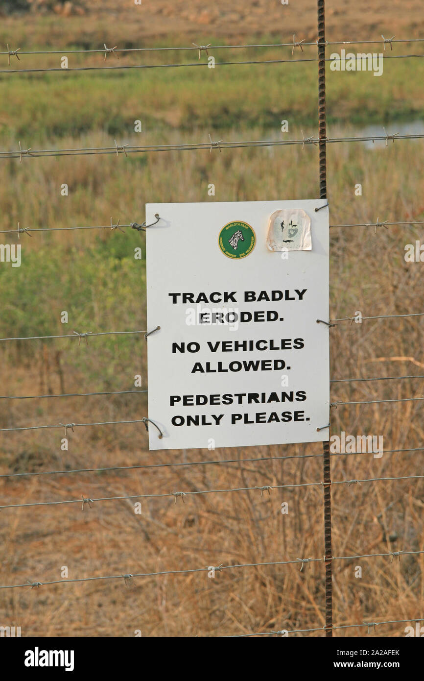 Pedestrians only sign on fence on dirt road in the bushveld, Marloth ...