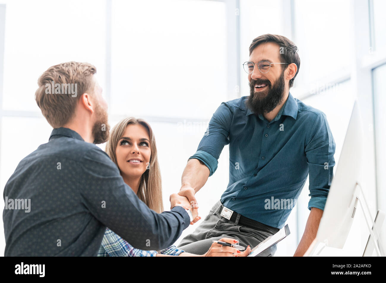 handshake employees in the workplace in the office Stock Photo - Alamy