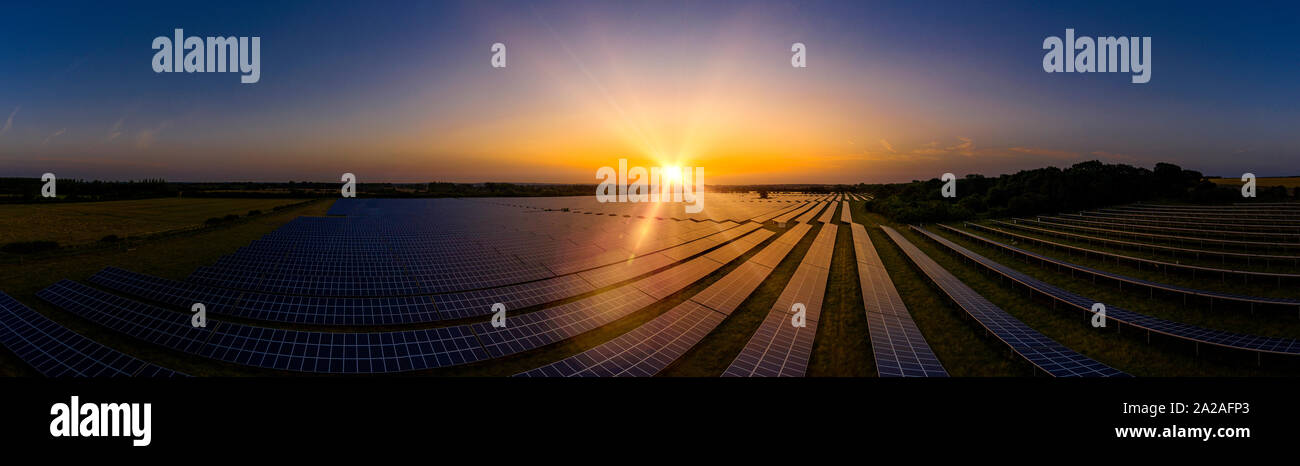 Modern solar farm panoramic at sunrise on a summers day Stock Photo - Alamy