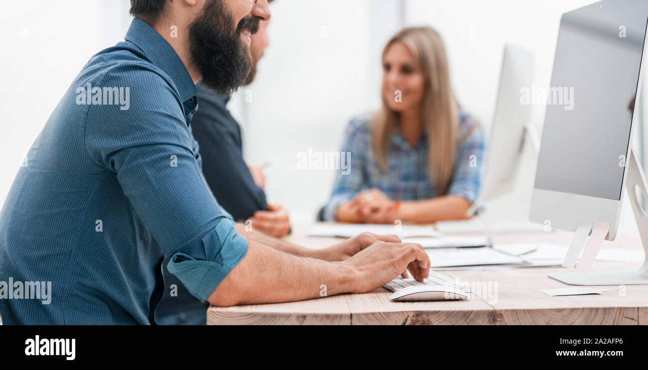 business team sitting at the Desk in the office Stock Photo - Alamy
