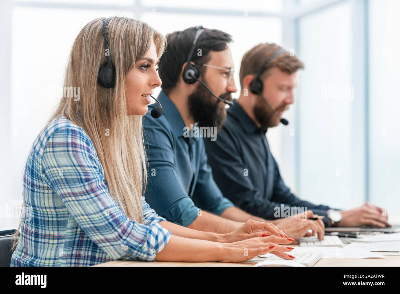 call center operators use computers to work with clients Stock Photo ...