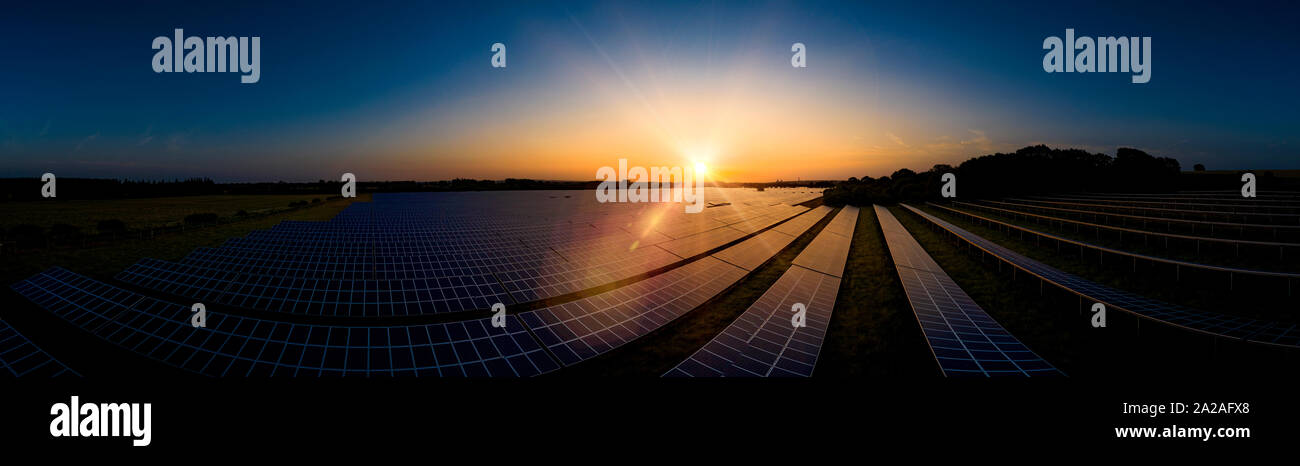 Modern solar farm panoramic at sunrise on a summers day Stock Photo - Alamy