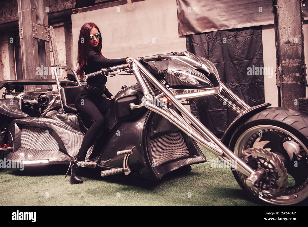 stylish young woman model posing near a chic tricycle Stock Photo - Alamy