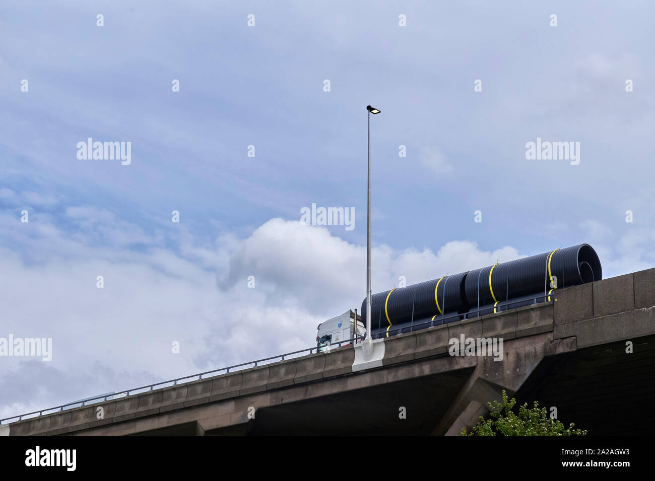 A lorry load of pipes on the M5 motorway viewed from the canal below ...