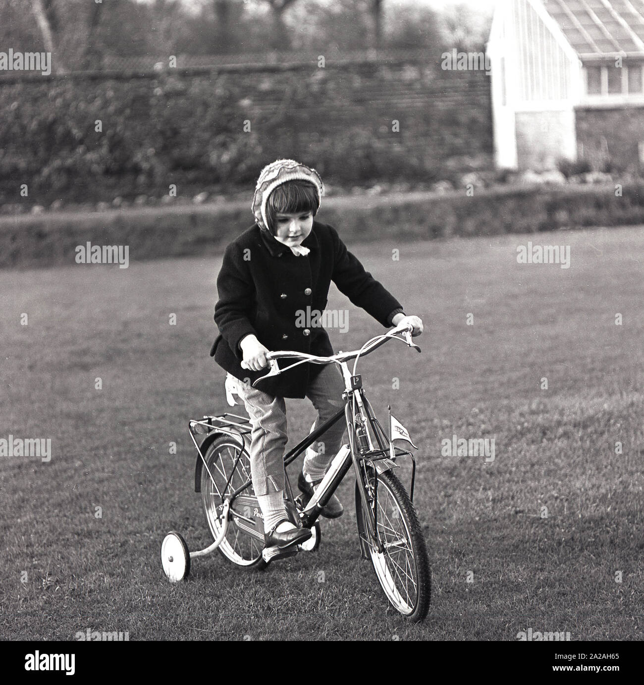 1960s, historical, a young girl on her Pavemaster bicycle, with ...