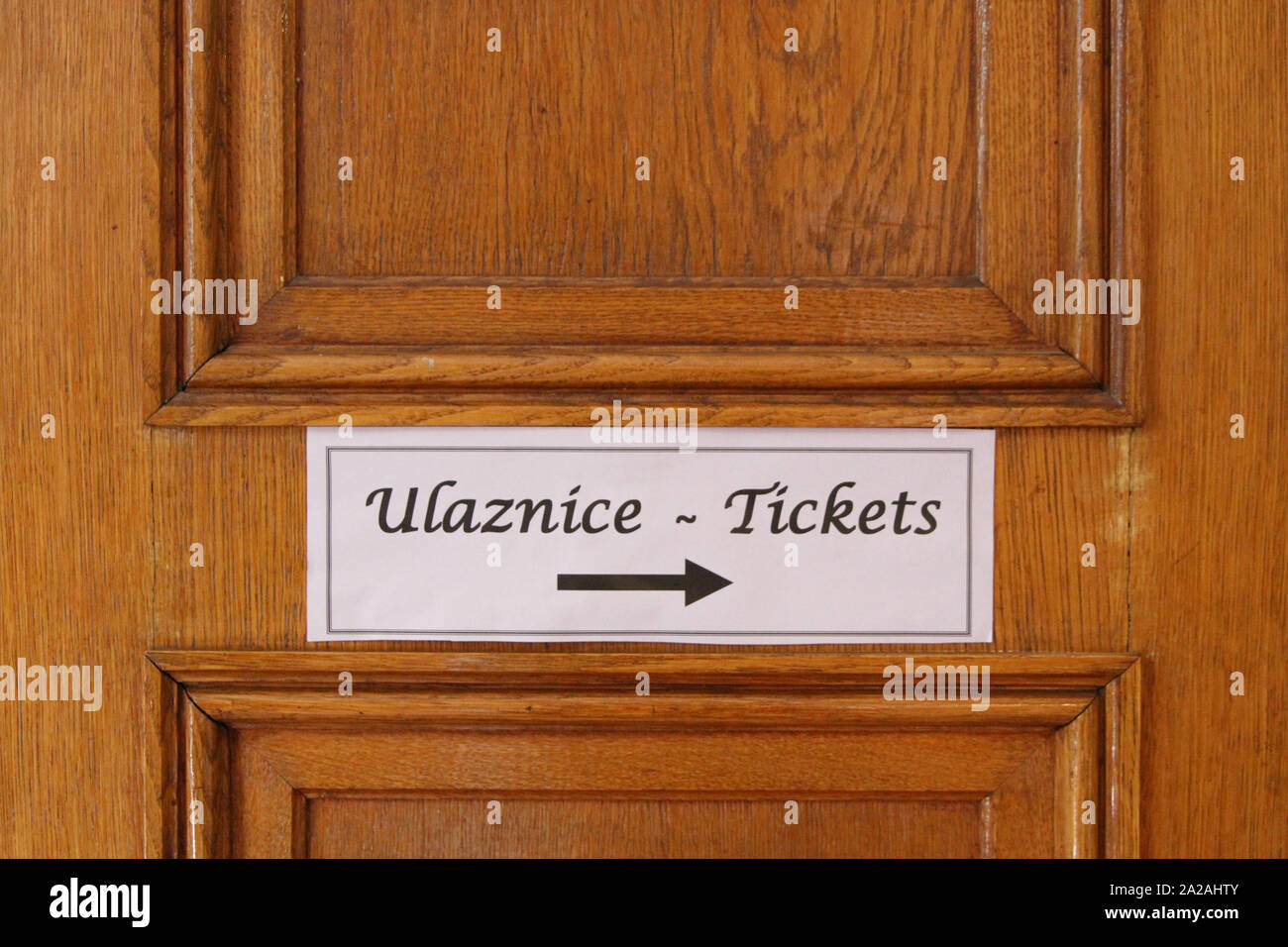 Wooden door with sign pointing to tickets purchase office, Nikola Tesla ...