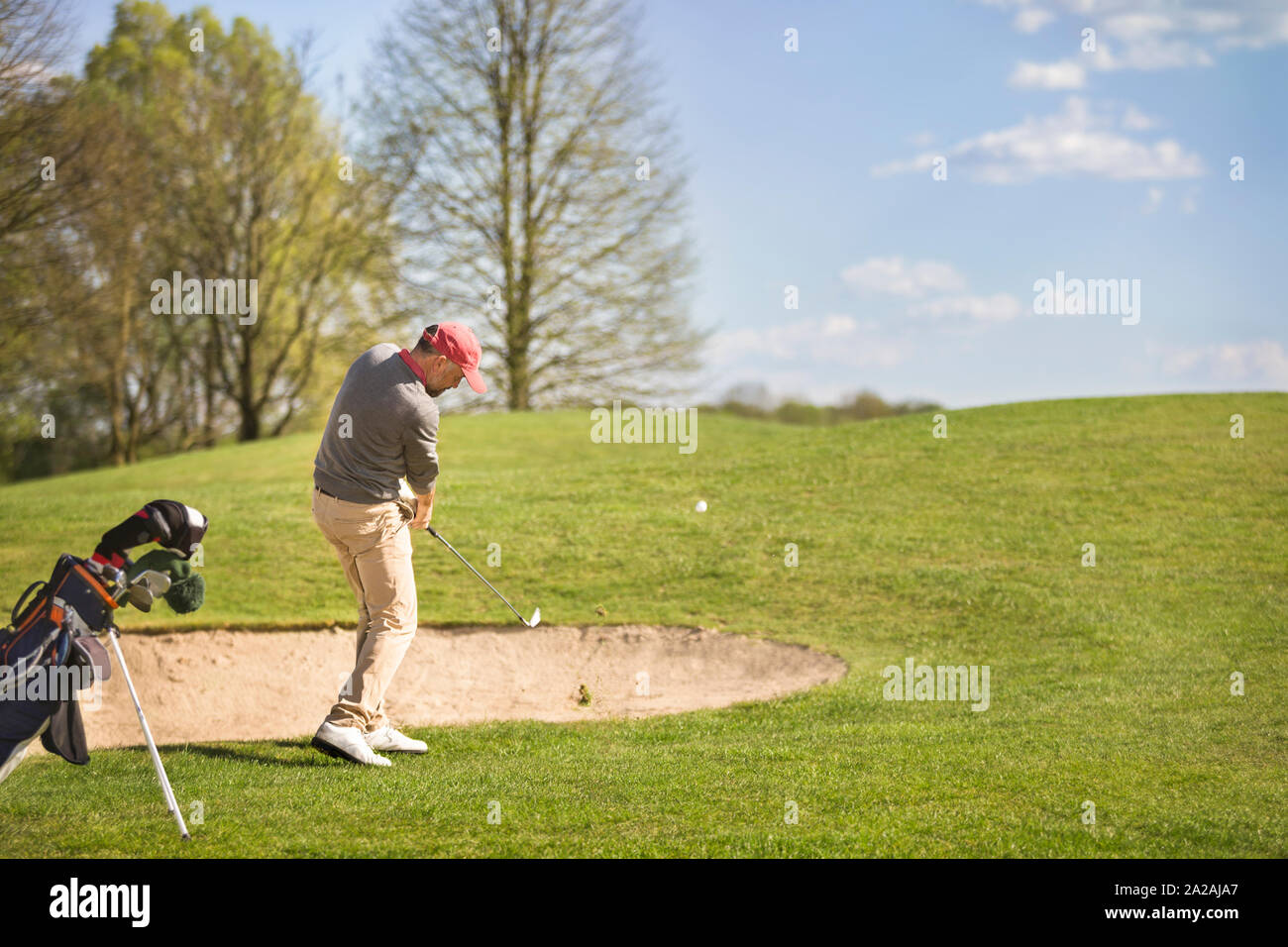 Golfer swinging on golf course hi-res stock photography and images - Alamy