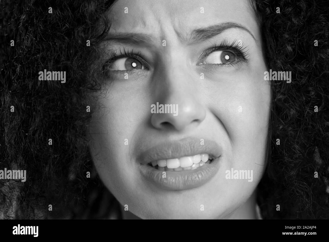 Disgusted girl looking scared in black and white Stock Photo - Alamy