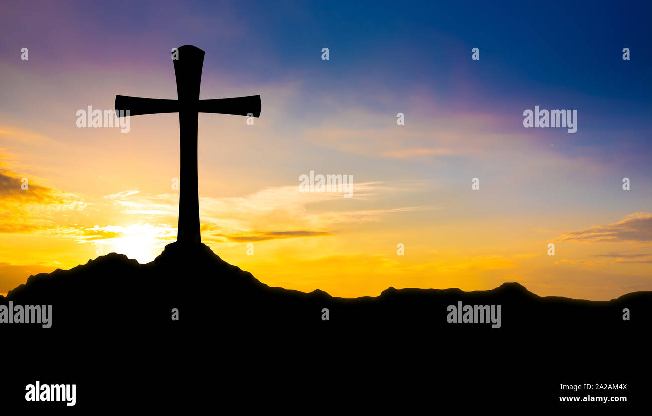 Cross on a hill at sunset Stock Photo - Alamy