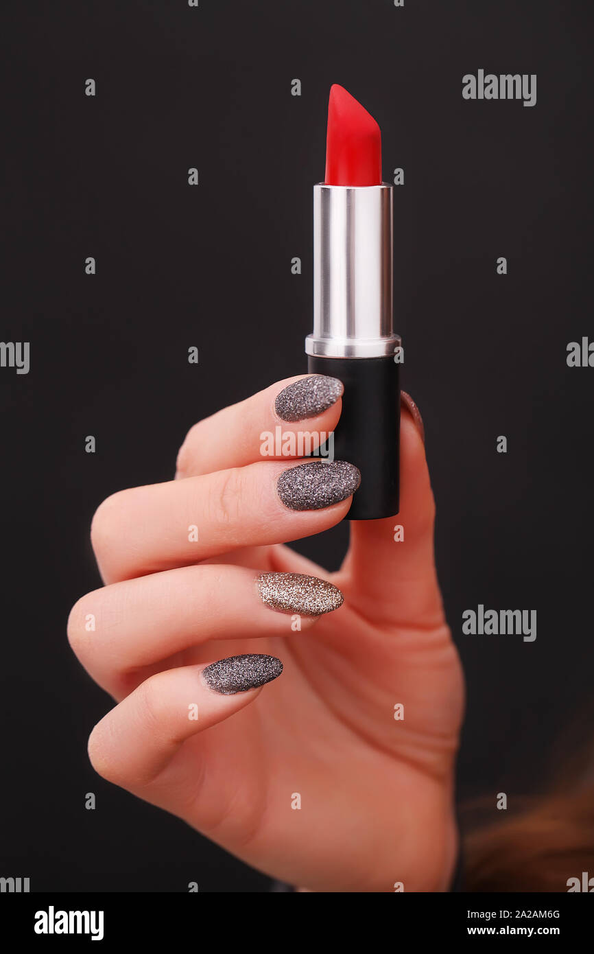 Red lipstick in a woman's hand Stock Photo - Alamy