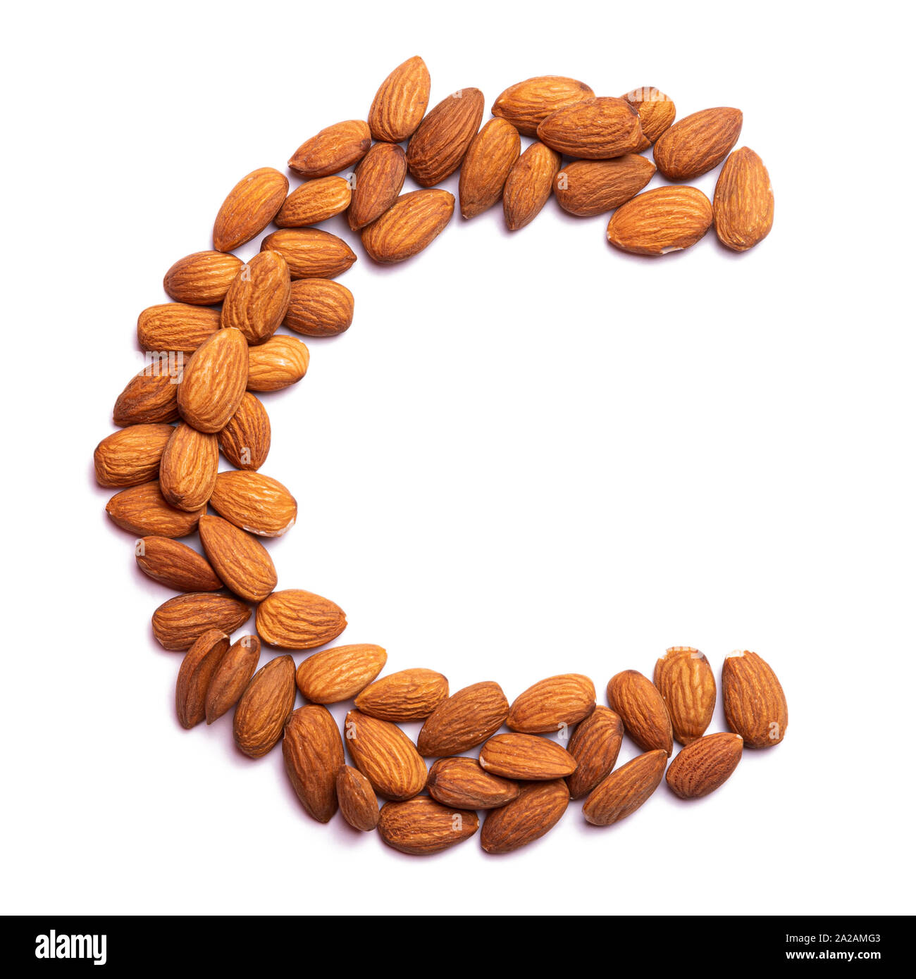 The letter "C" of the English alphabet from a peeled almond on a white ...