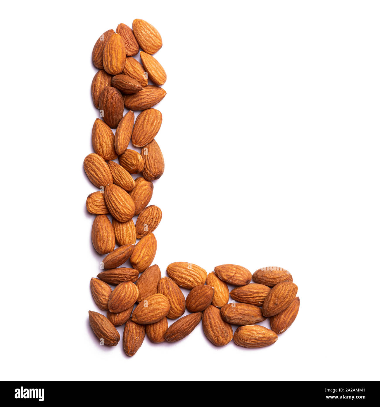 The letter "L" of the English alphabet from a peeled almond on a white ...
