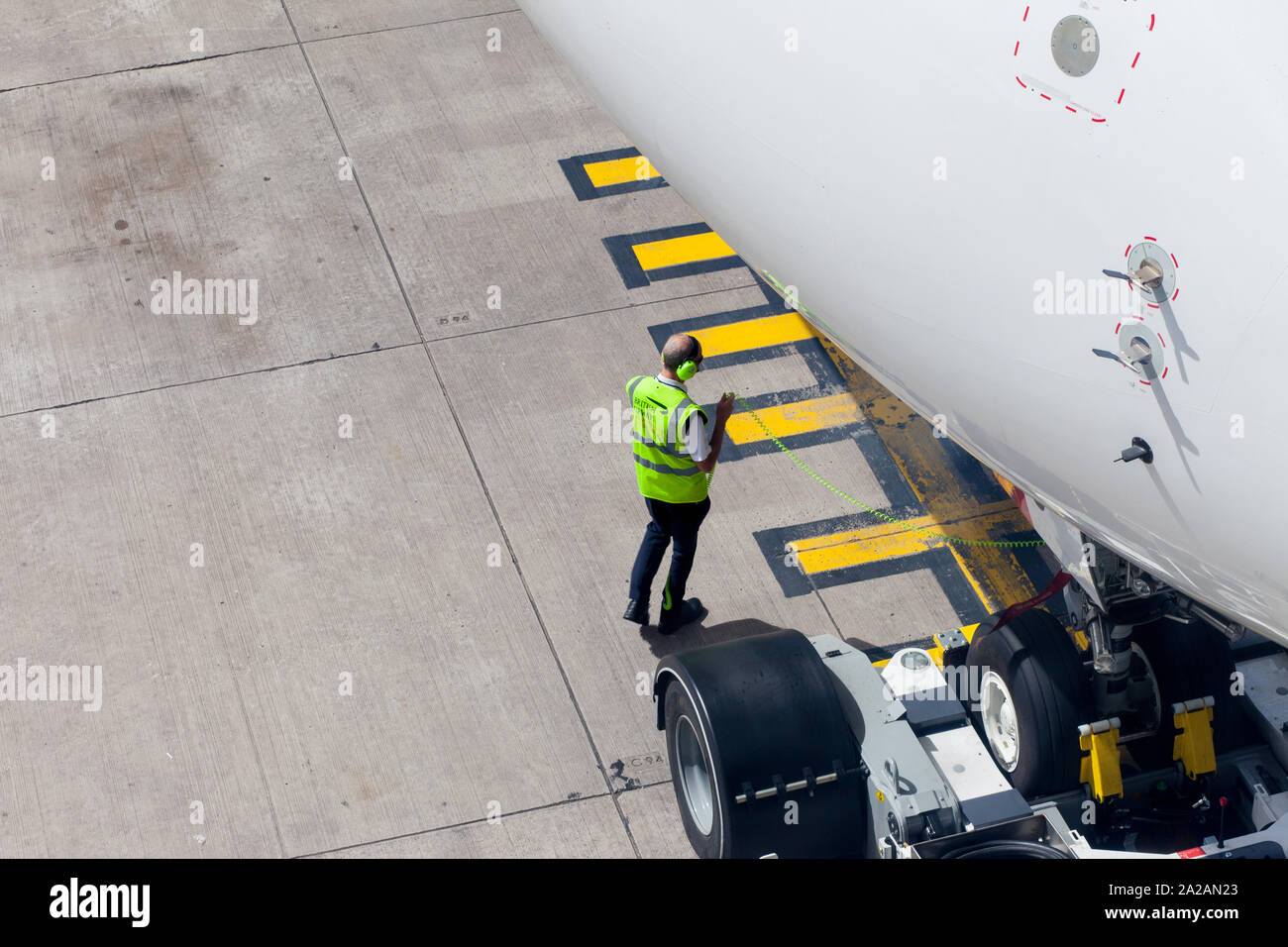 A British Airways dispatcher walking around a aircraft, getting ready ...