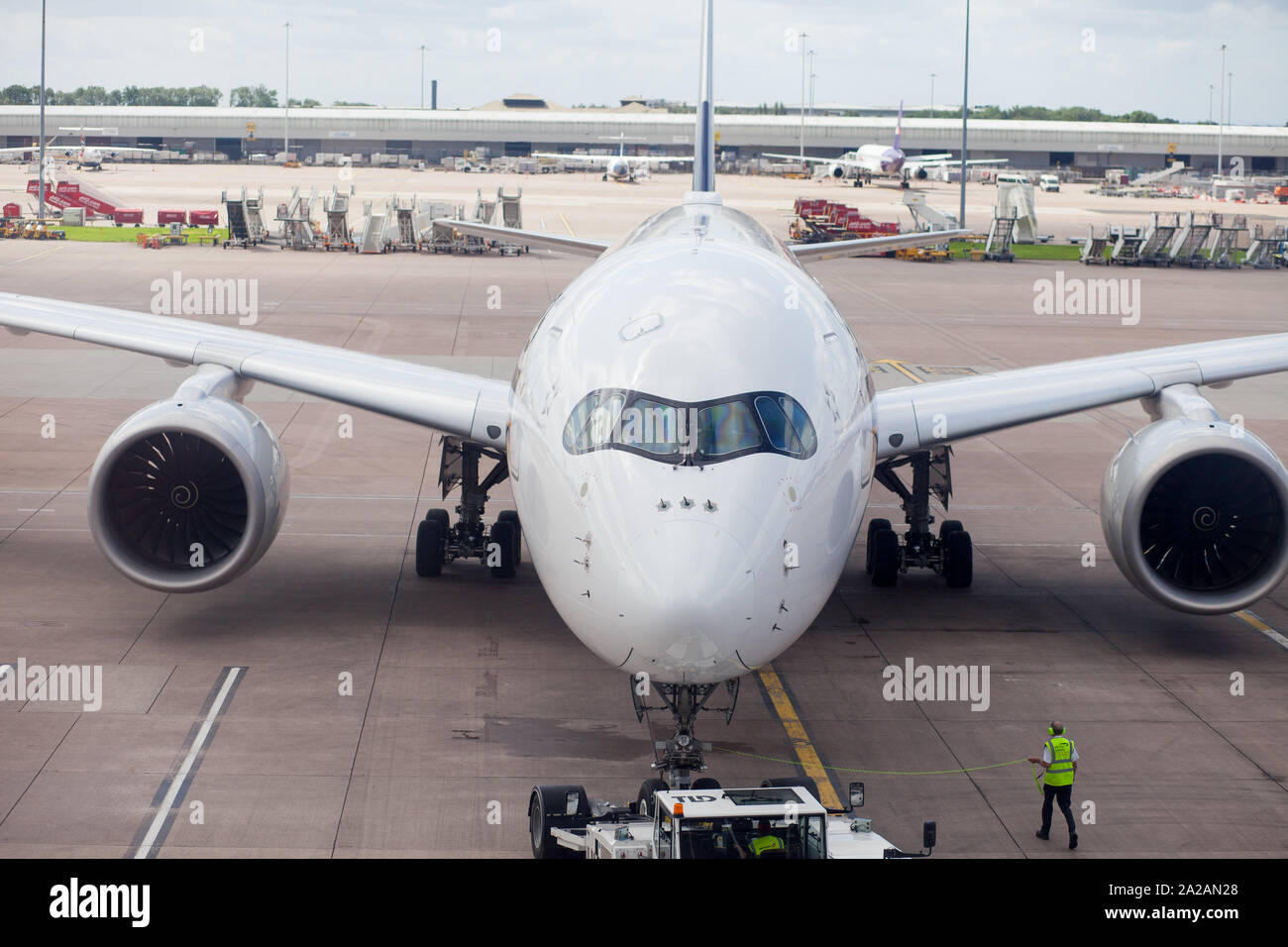 A taxiing aircraft being pushed back for its departure. You can see the ...