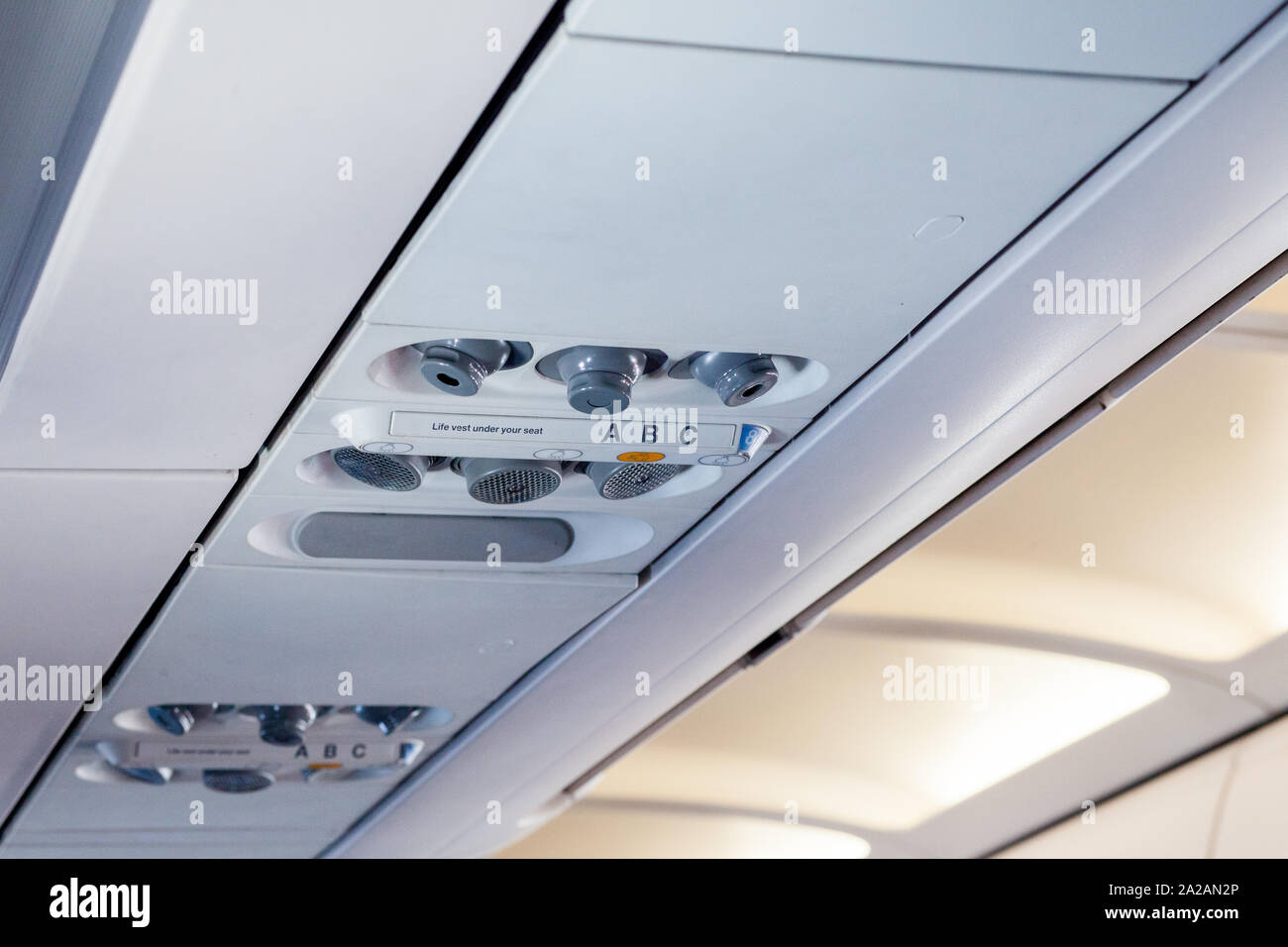 Interior shot of a passenger airliner/aircraft, with passengers sitting ...