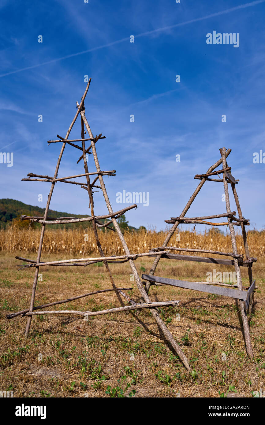 Empty scaffolds or frames used to dry hay in a corn field Stock Photo ...