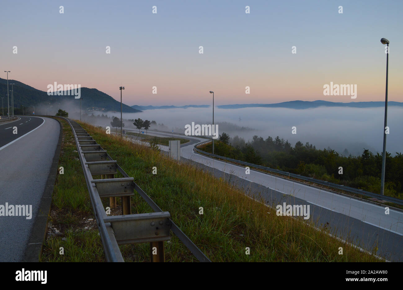 Empty highway at dawn, Gacka valley covered with mist, Croatia Stock ...