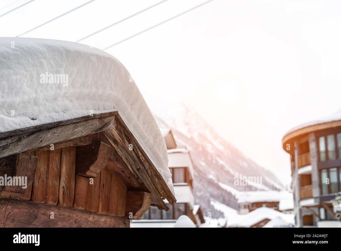 Austrian alpine village scenic landscape with wooden barn roof covered ...