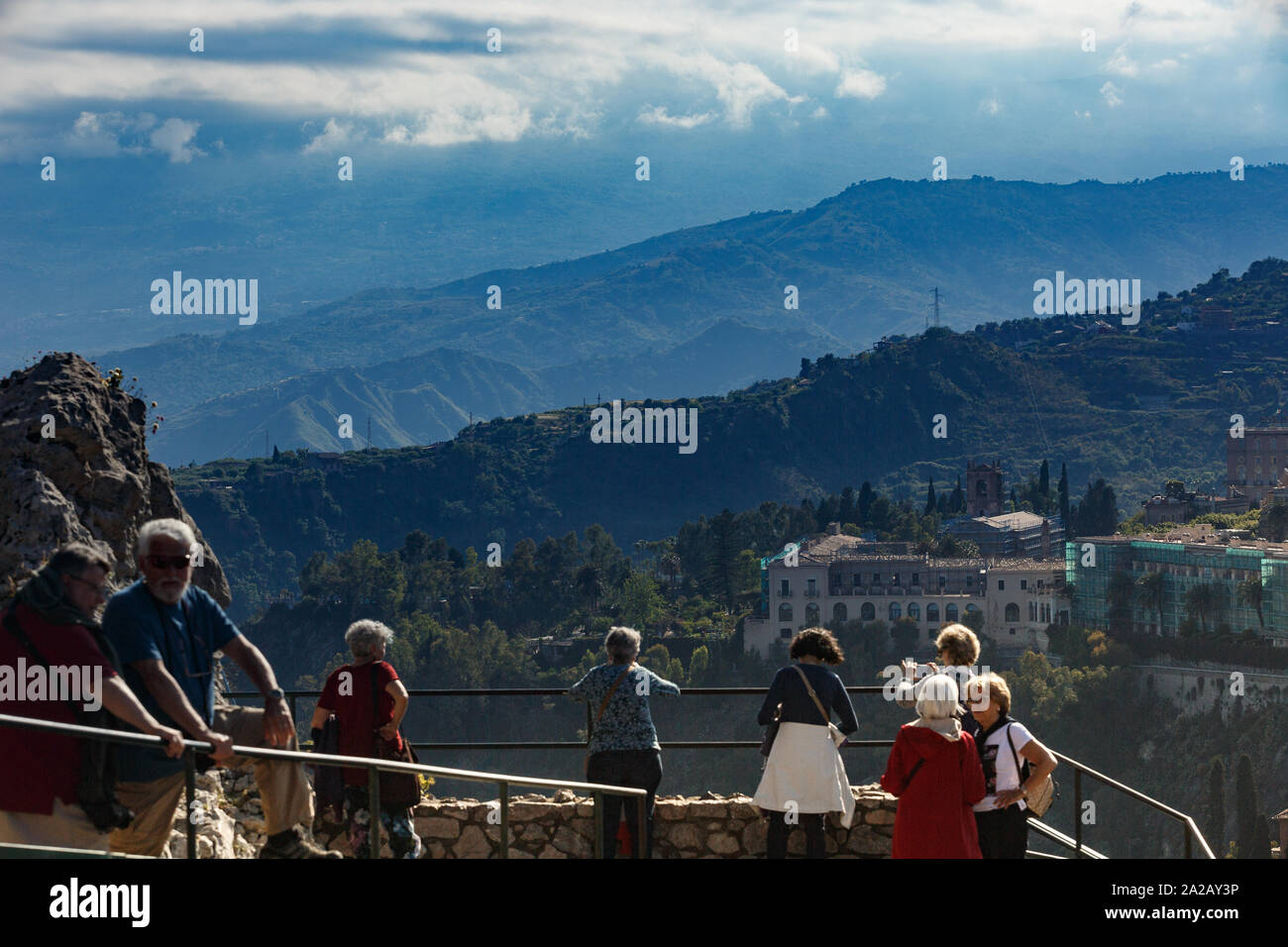 Crowd of tourists admiring Taormina aerial view from Greek amphitheater ...