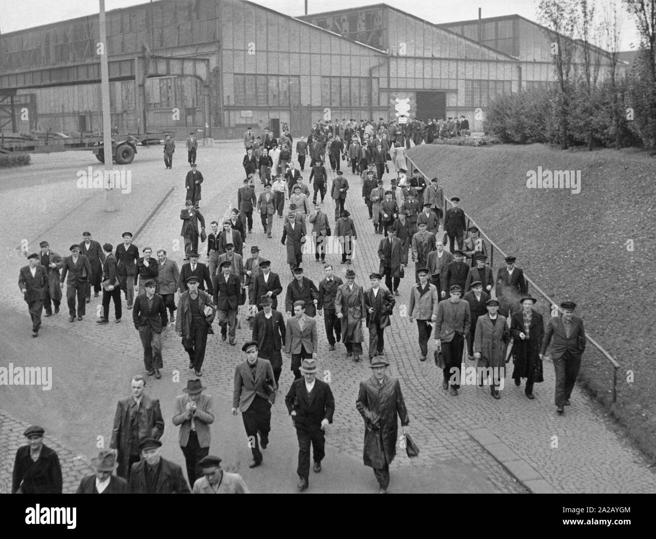 Industry workers leaving the factory premises Stock Photo - Alamy