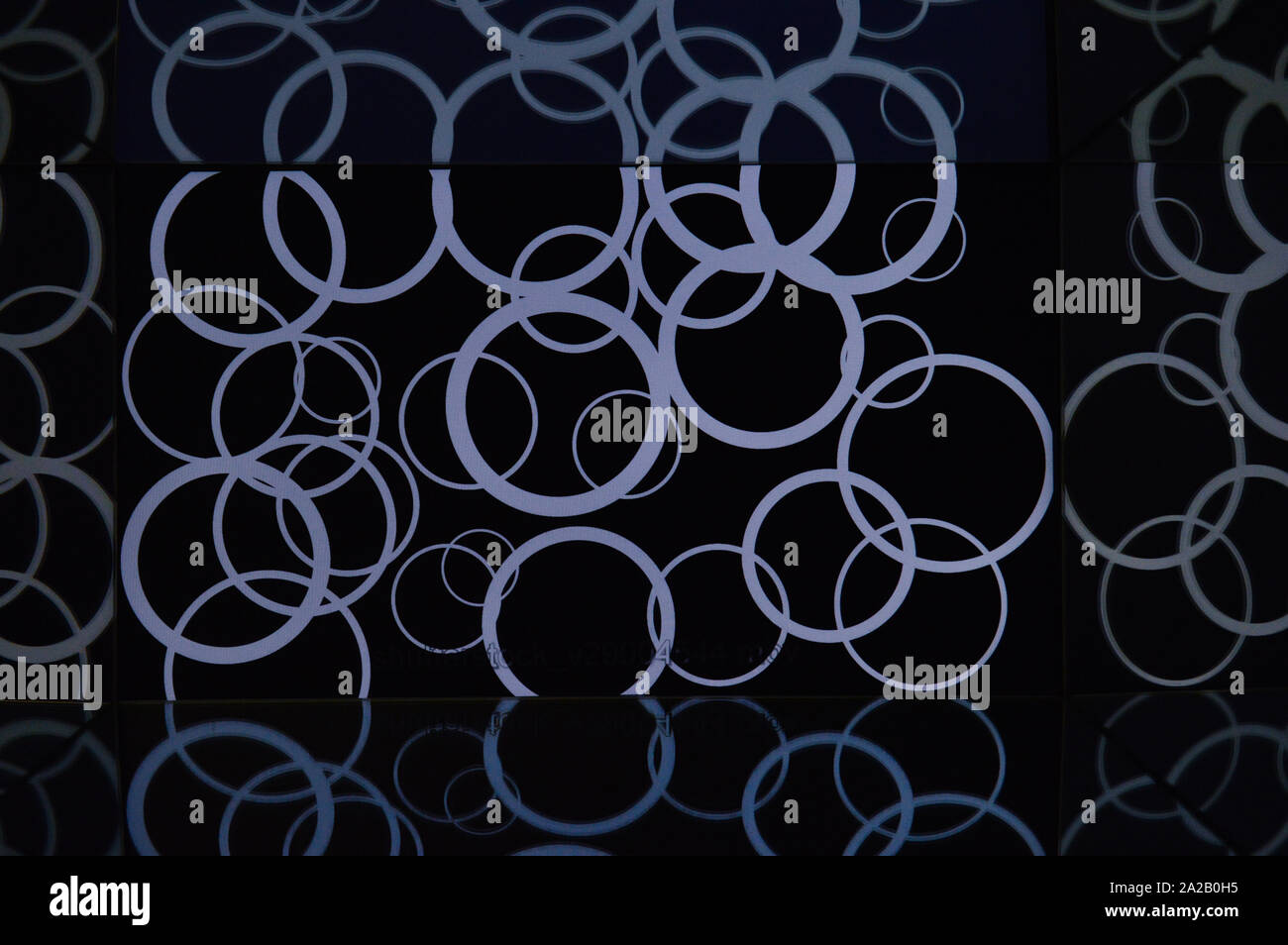 Circles and their reflections on black mirror background Stock Photo ...