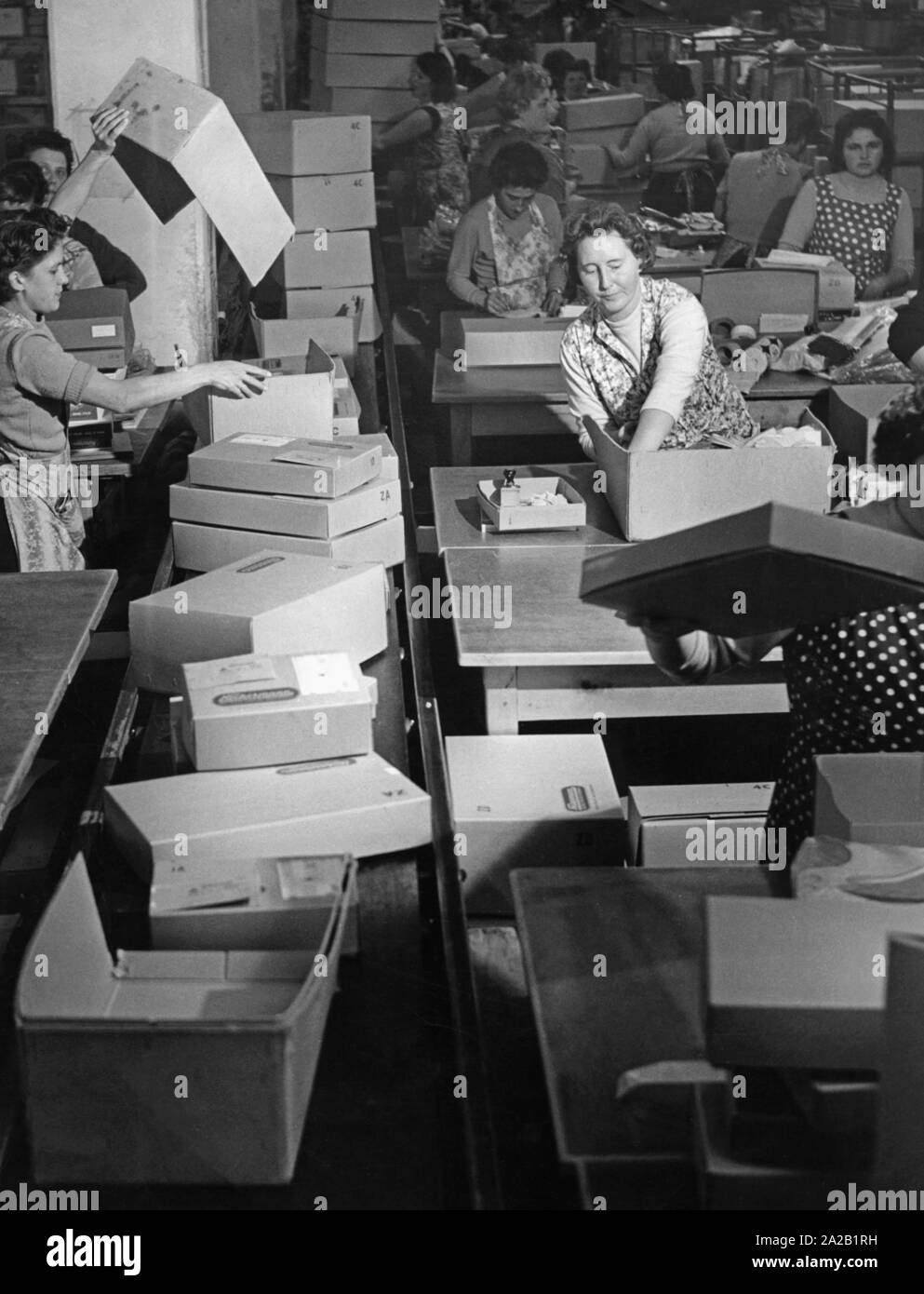 Women pack goods for shipping Stock Photo - Alamy