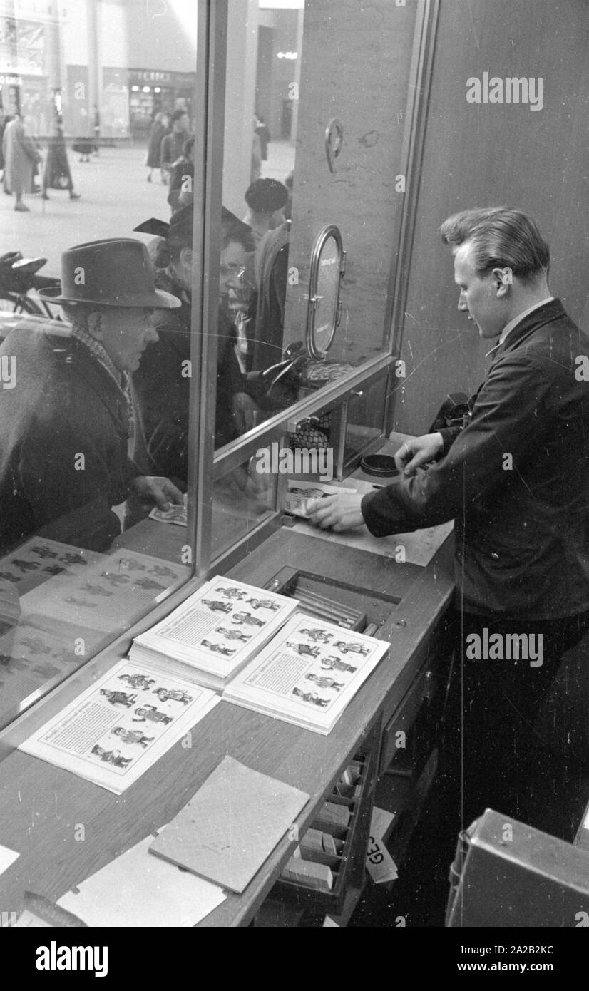 A ticket seller of the Deutsche Bundesbahn (German Federal Railway ...