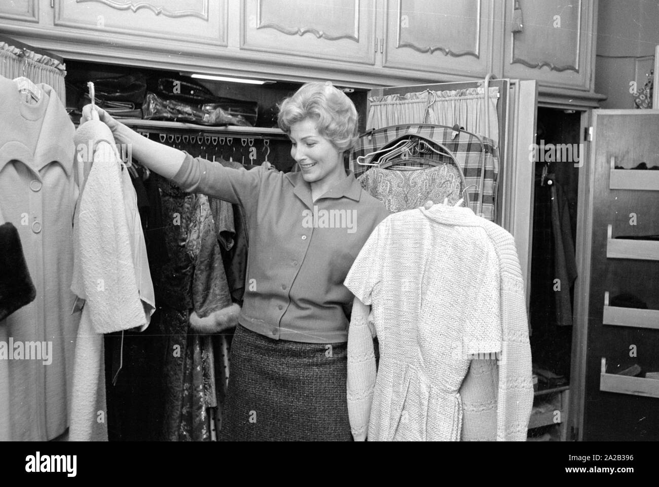 The singer and actress stands in front of her large, open wardrobe and ...