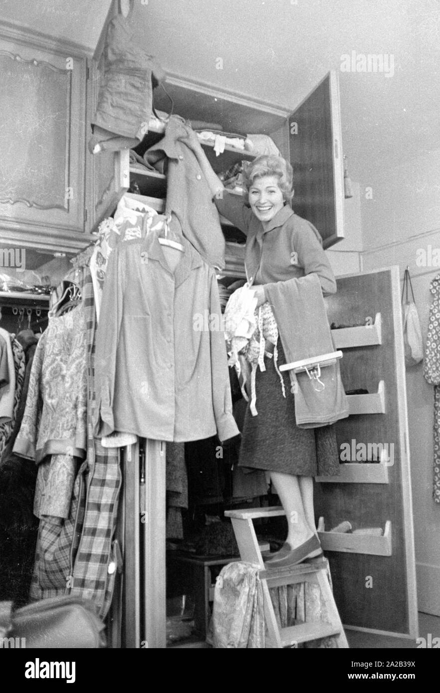 The singer and actress stands in front of her large, open wardrobe and ...