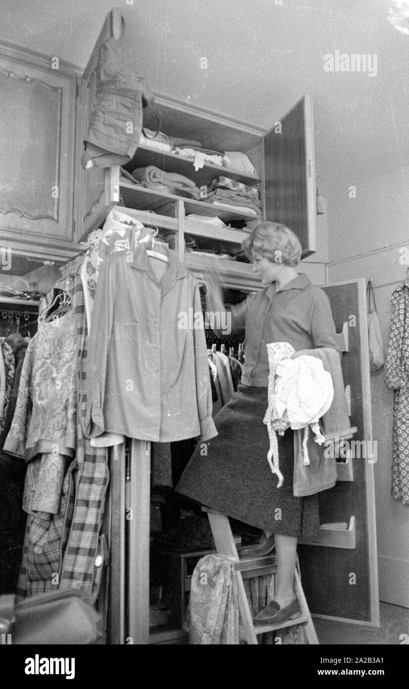 The singer and actress stands in front of her large, open wardrobe and ...