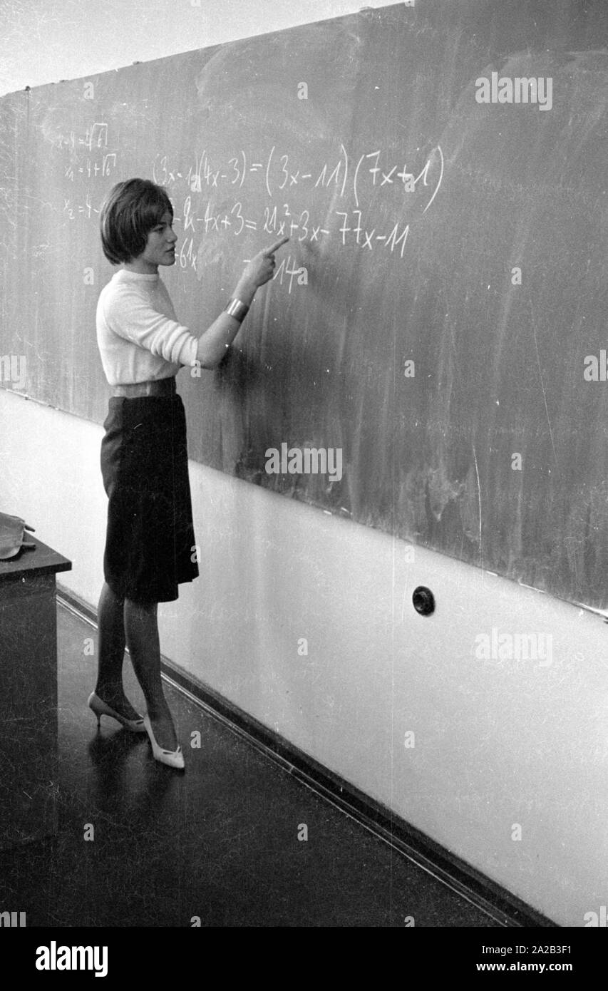 Math class at a school in Germany. A student solves a problem on the ...