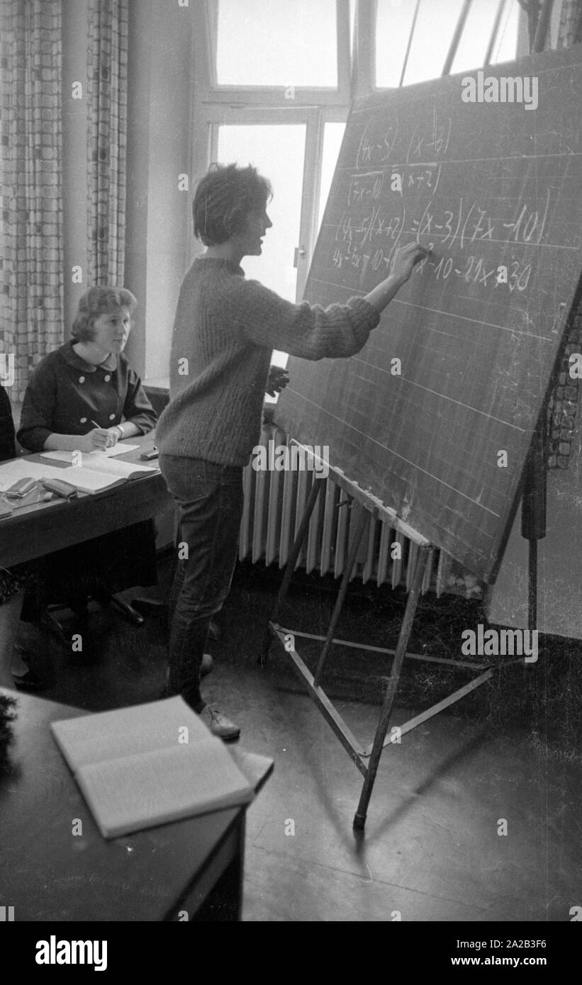 Math class at a school in Germany. A student solves a problem on the ...