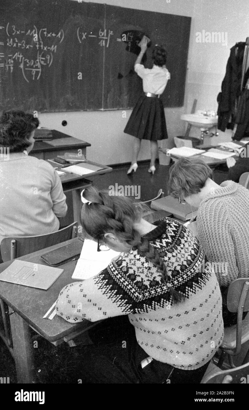 Math class at a school in Germany. A student solves a problem on the ...