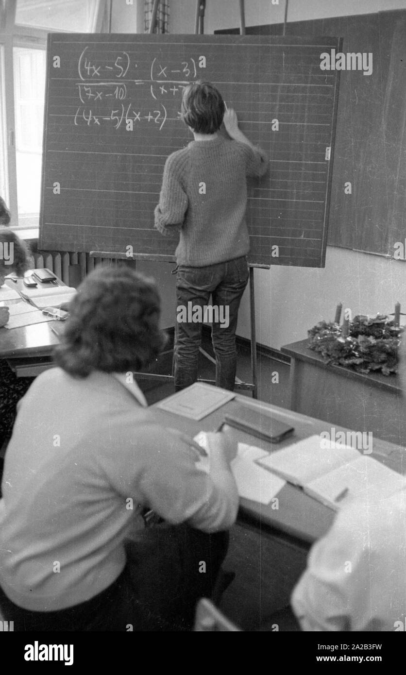 Math class at a school in Germany. A student solves a problem on the ...