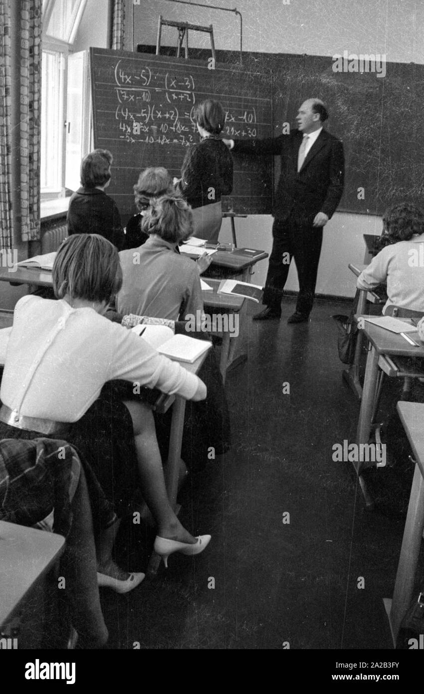 Math class at a school in Germany. A student solves a problem on the ...