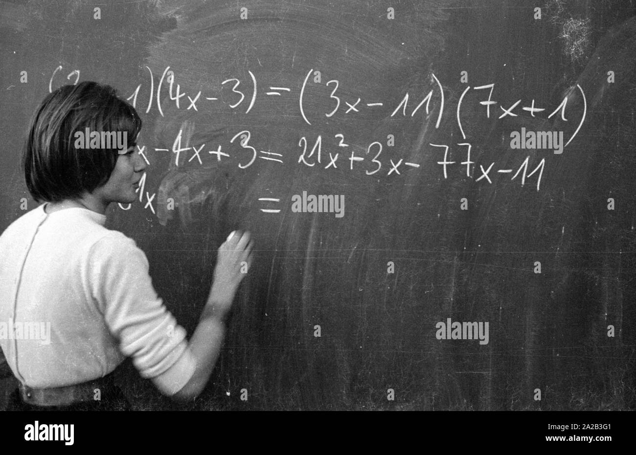 Math class at a school in Germany. A student solves a problem on the ...
