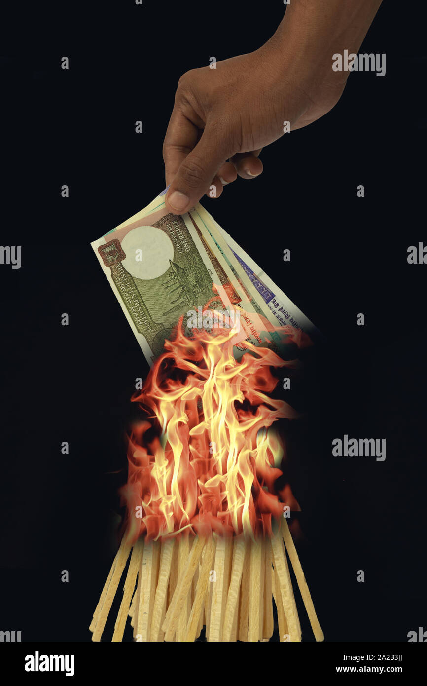 man's hand holding Indian Currency and burning in Fire on Isolated ...