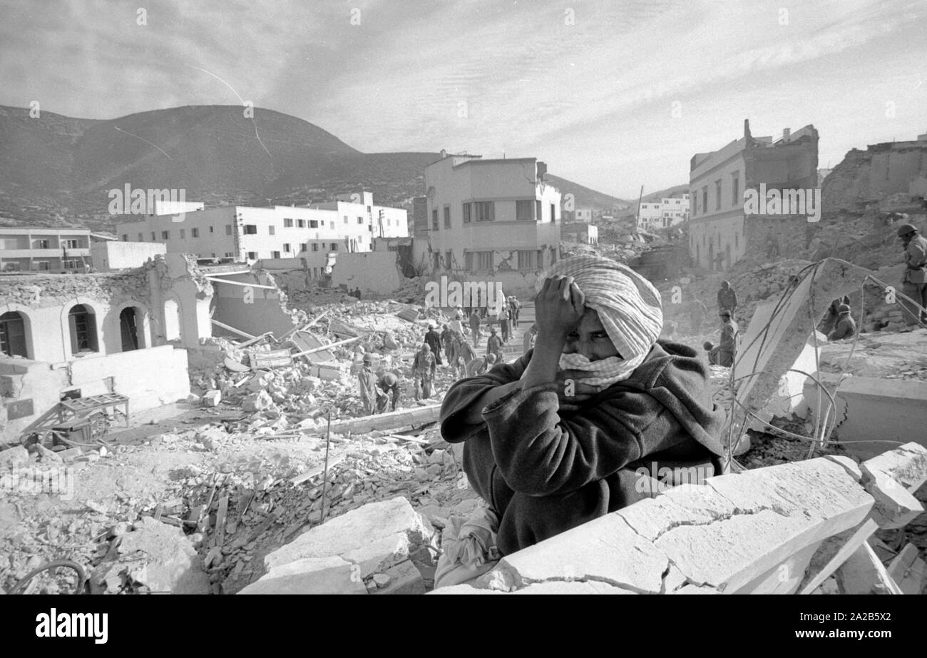 A man in front of the ruins of the destroyed city. From the report ...