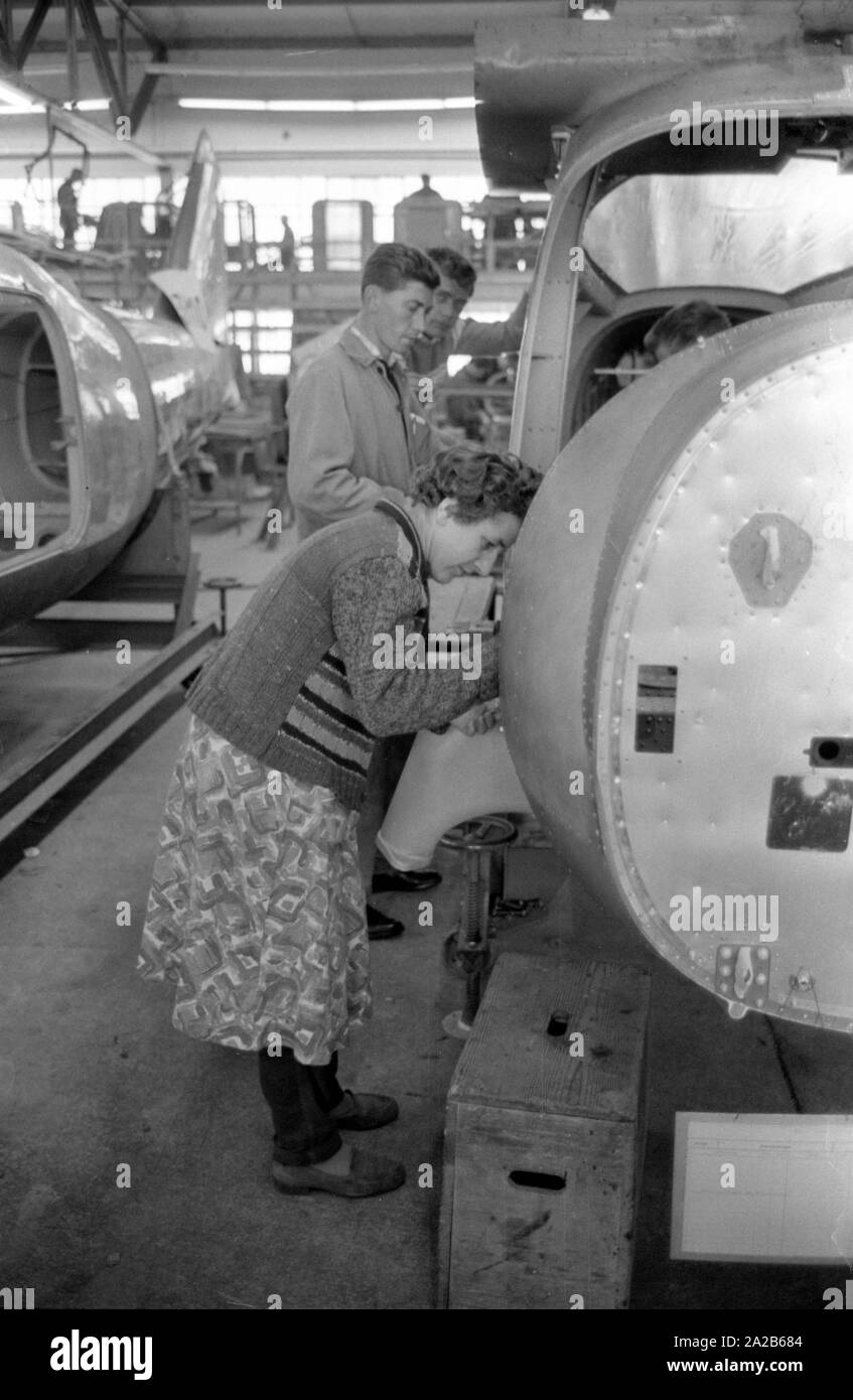 Workers in the factory hall working on a plane Stock Photo - Alamy