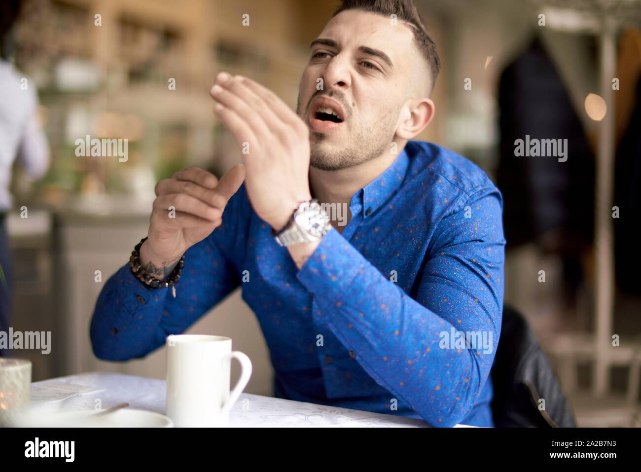 Awkward man sitting hi-res stock photography and images - Alamy