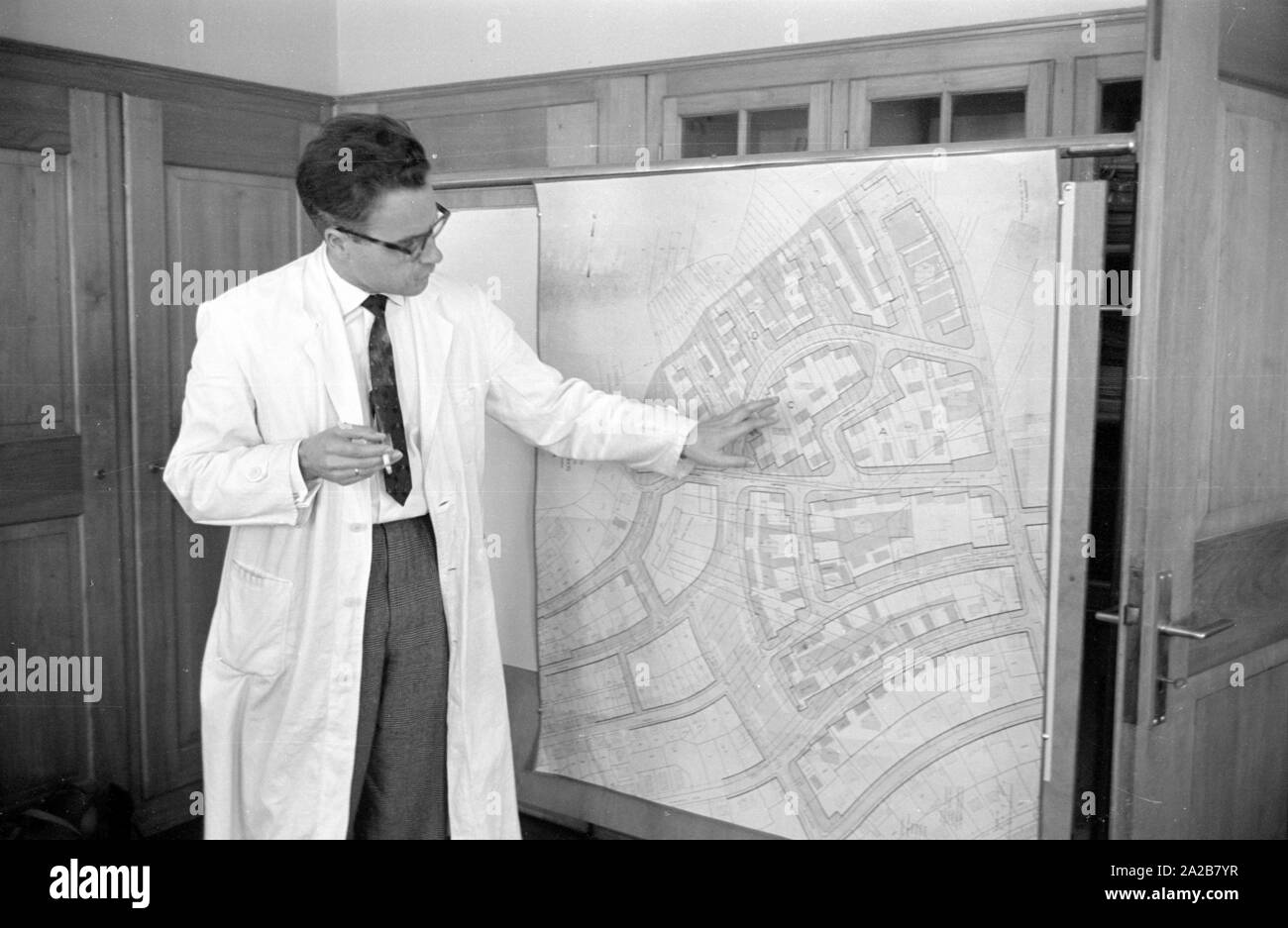 A man explains the planned development area with the aid of a drawing ...