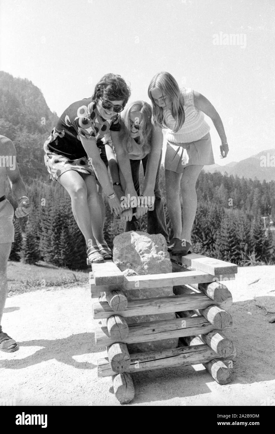 Three women try the stone lifting, a traditional alpine competition ...
