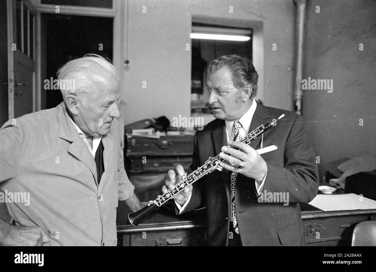 A musician shows his oboe to an expert Stock Photo - Alamy