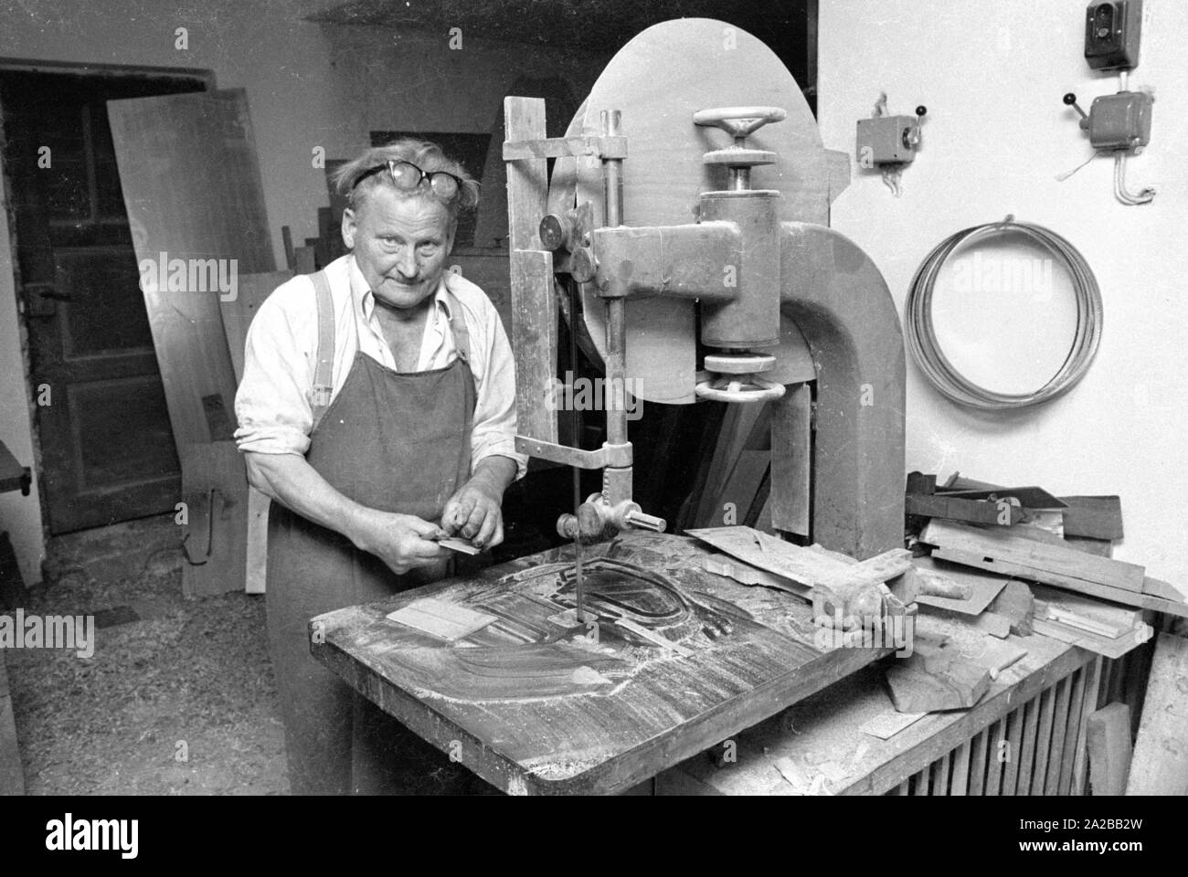 View into a joiner's workshop: the master joiner operates a machine ...